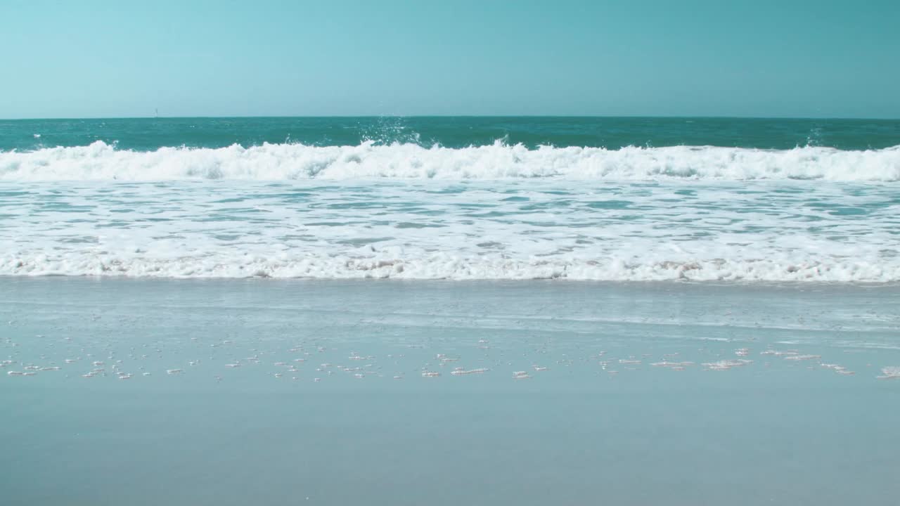 Premium stock video - Waves on the shoreline come toward the camera on ...