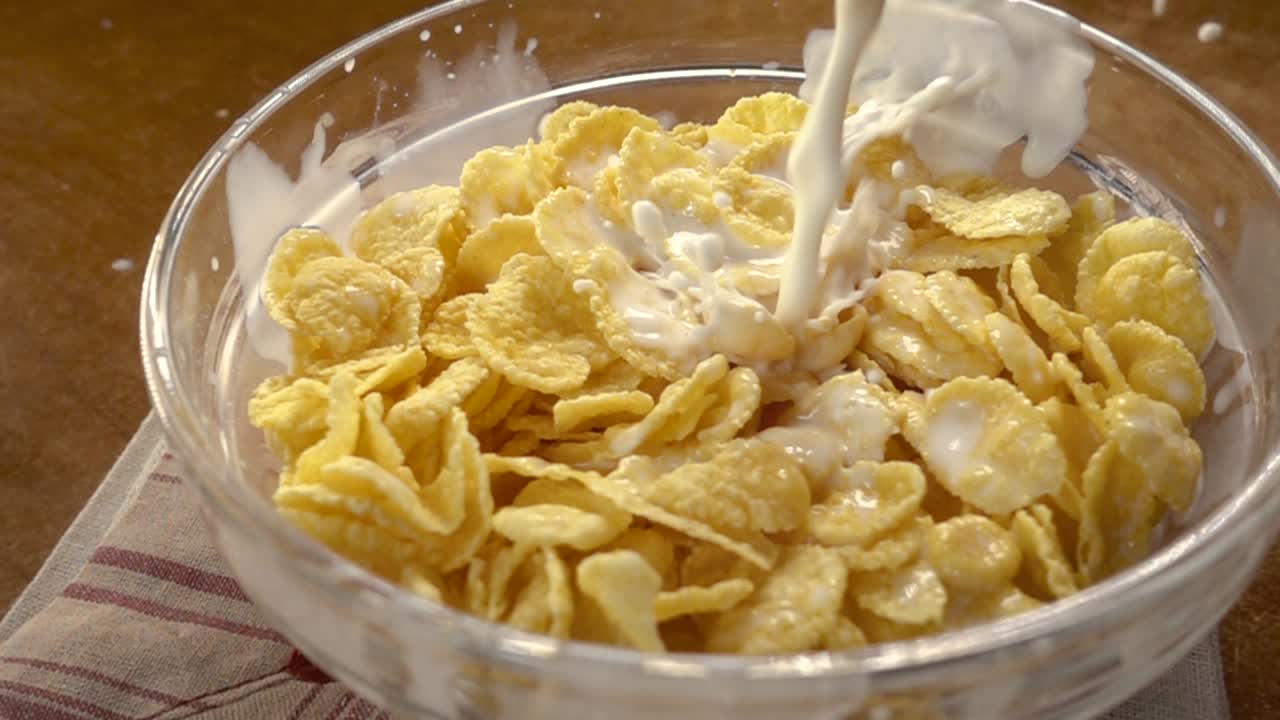 Crispy yellow corn flakes into the bowl for the morning a delicious ...