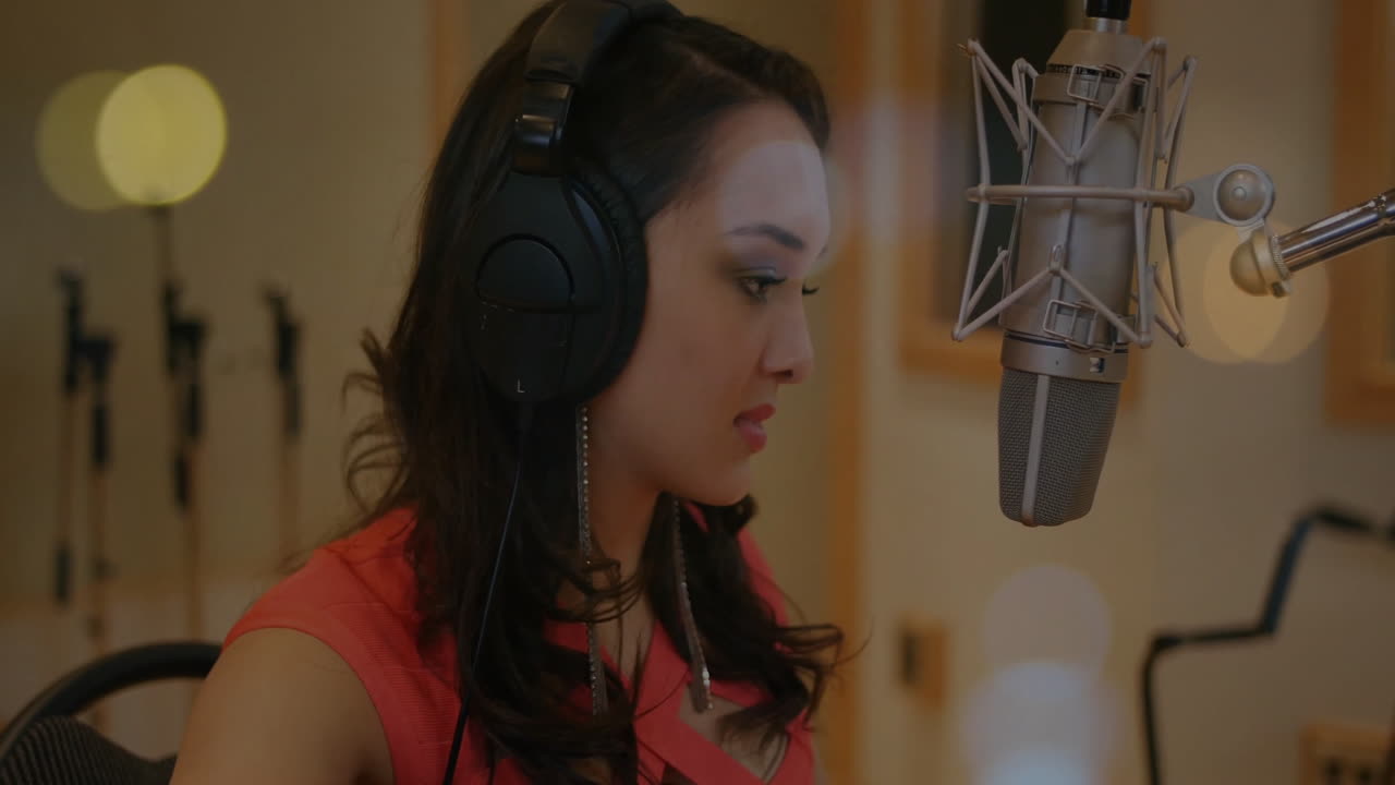 Woman recording vocals in music studio, showcasing animated sound waves ...