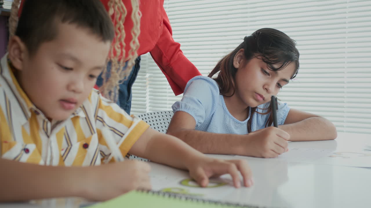 Speech Therapist Helping Two Children Writing Letters on Worksheet ...