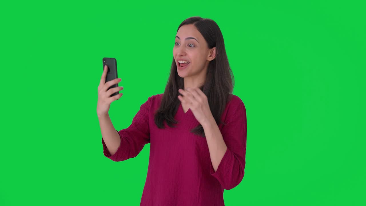 Happy indian woman talking on video call green screen Premium Stock ...