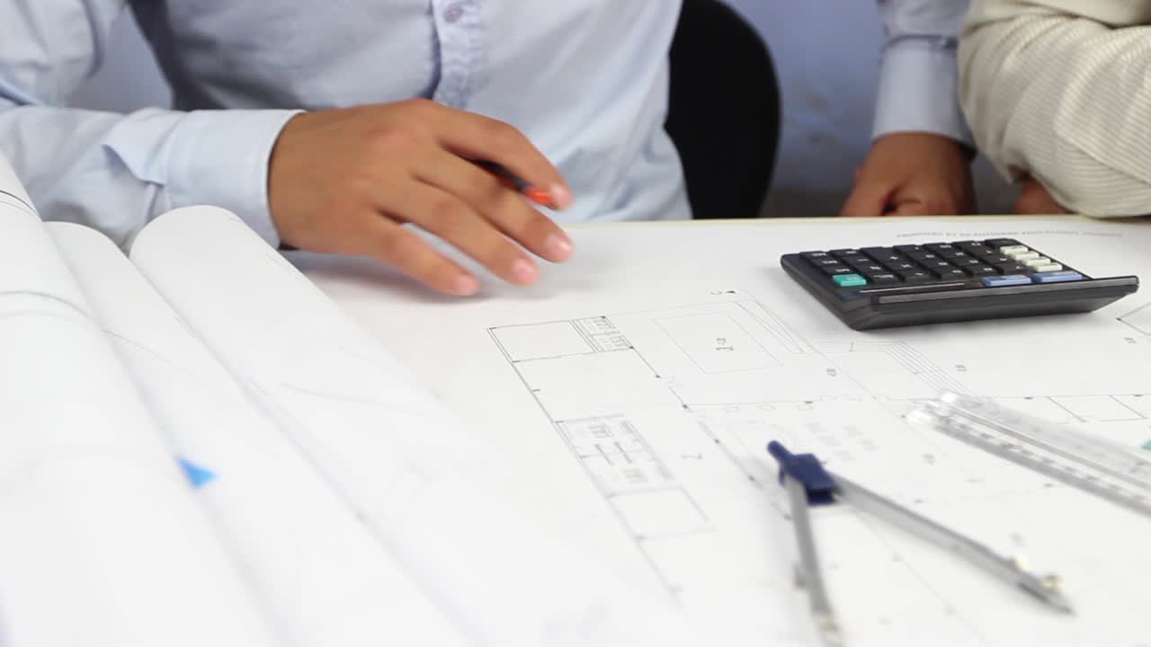 Premium stock video - Architect working construction plan 1
