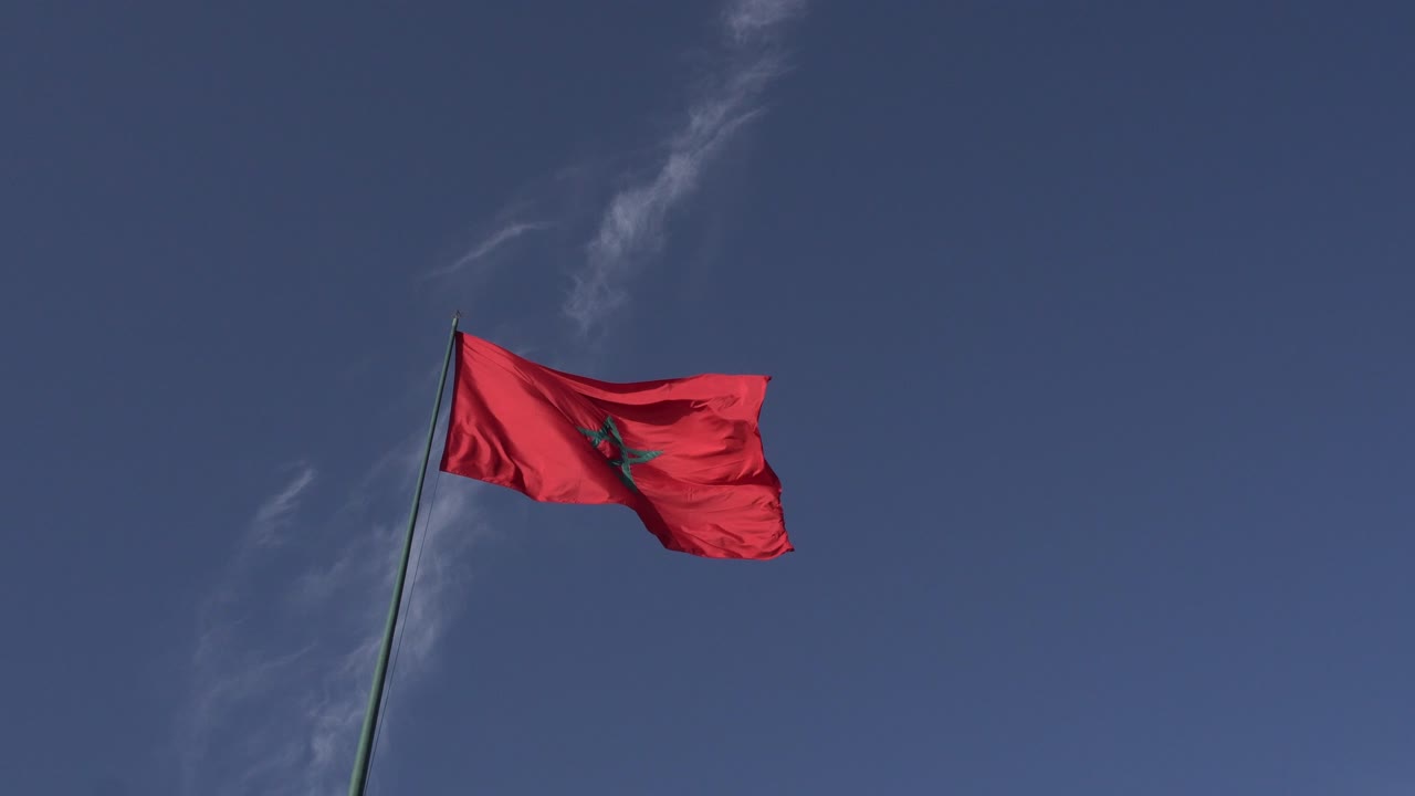 The Moroccan flag moving under a blue sky with a few clouds | Premium ...