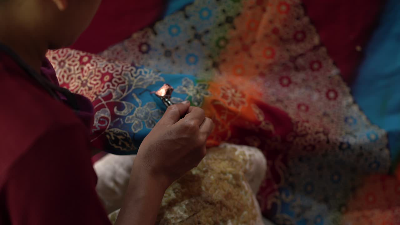 Premium stock video - Close up, women make batik fabrics in a ...