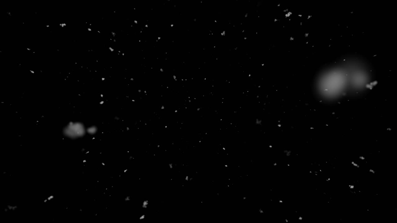 Realistic heavy snow flurry with varied particle sizes falls against ...
