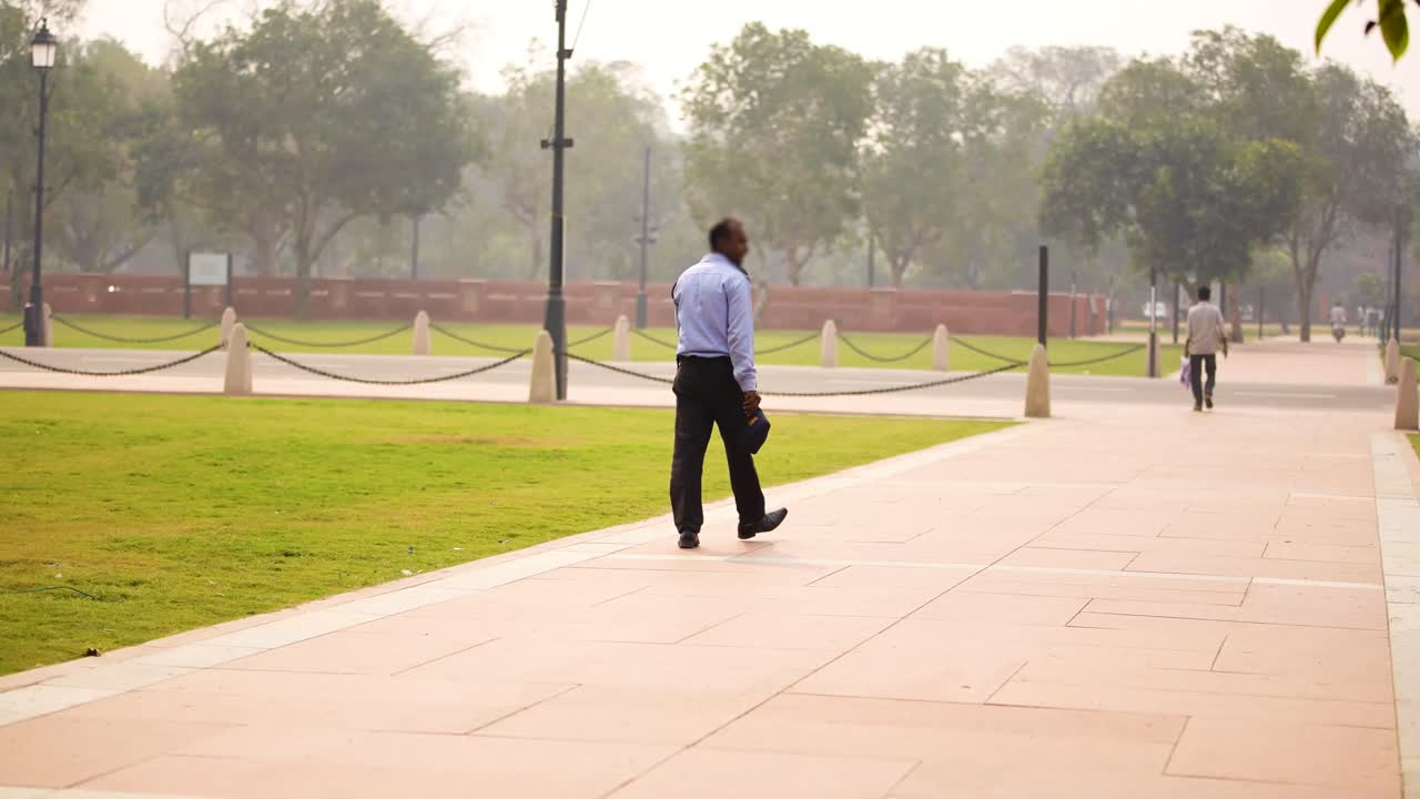 Security guard walking at india gate pathway Premium Stock Video Footage