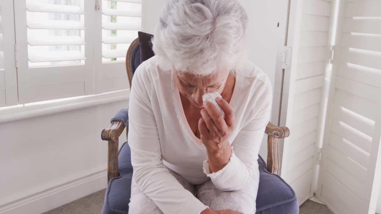 Senior african american woman crying and weeping tears with tissue at ...