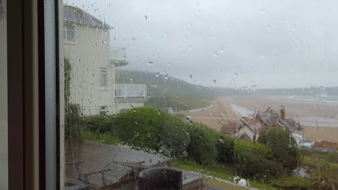 Rain Drops Hitting A Glass Window With A Beach View In Slow Motion Free ...