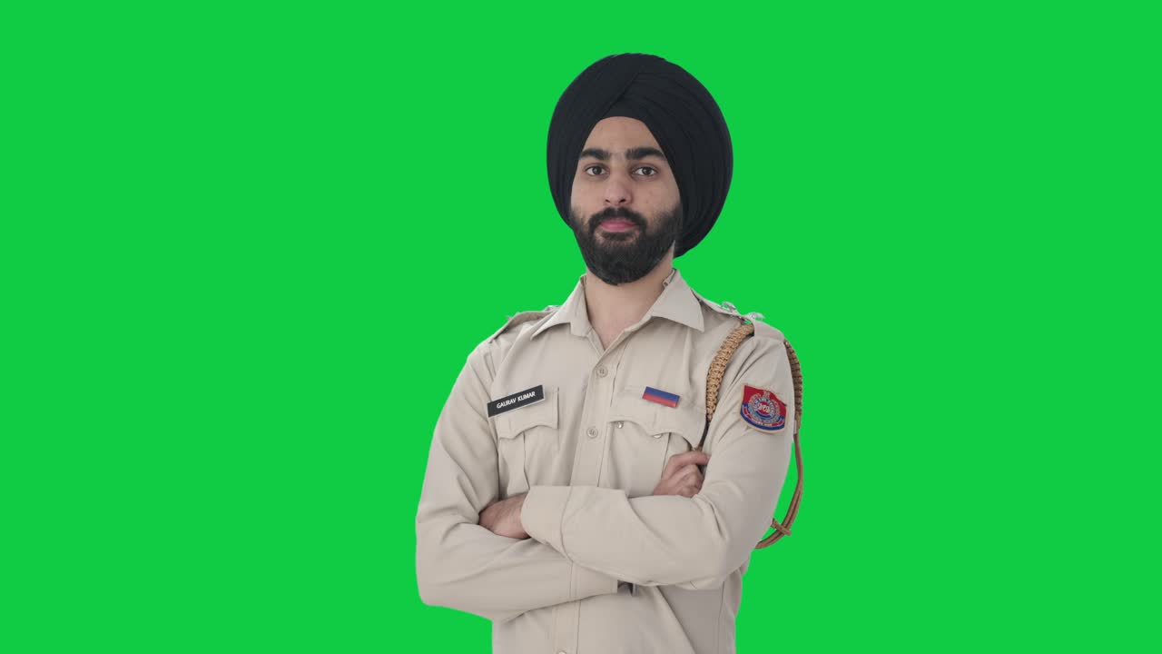 Portrait Of Confident Sikh Policeman Standing Crossed Hands Green ...