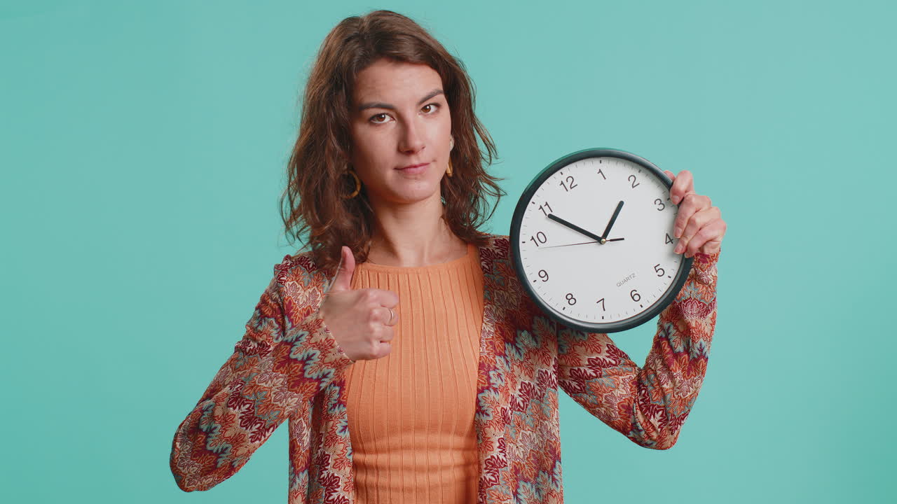 Woman pointing at a clock | Premium Stock Video Footage