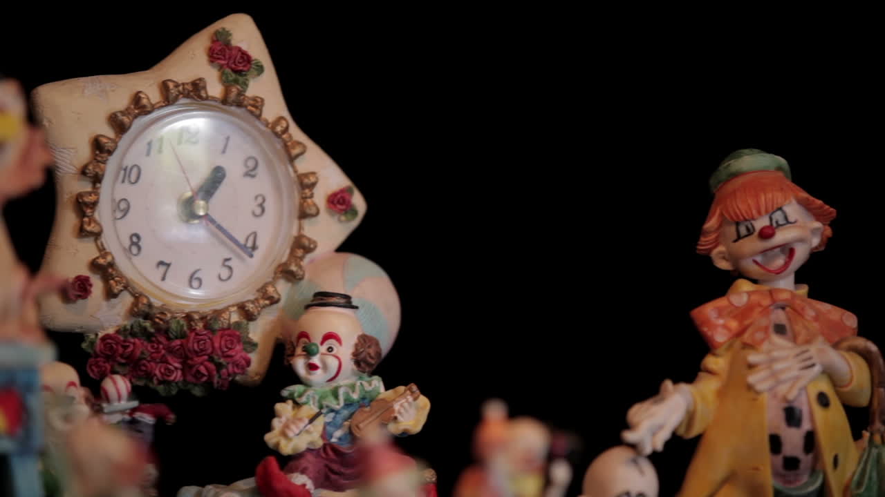 Premium stock video - Clown figurines and clock