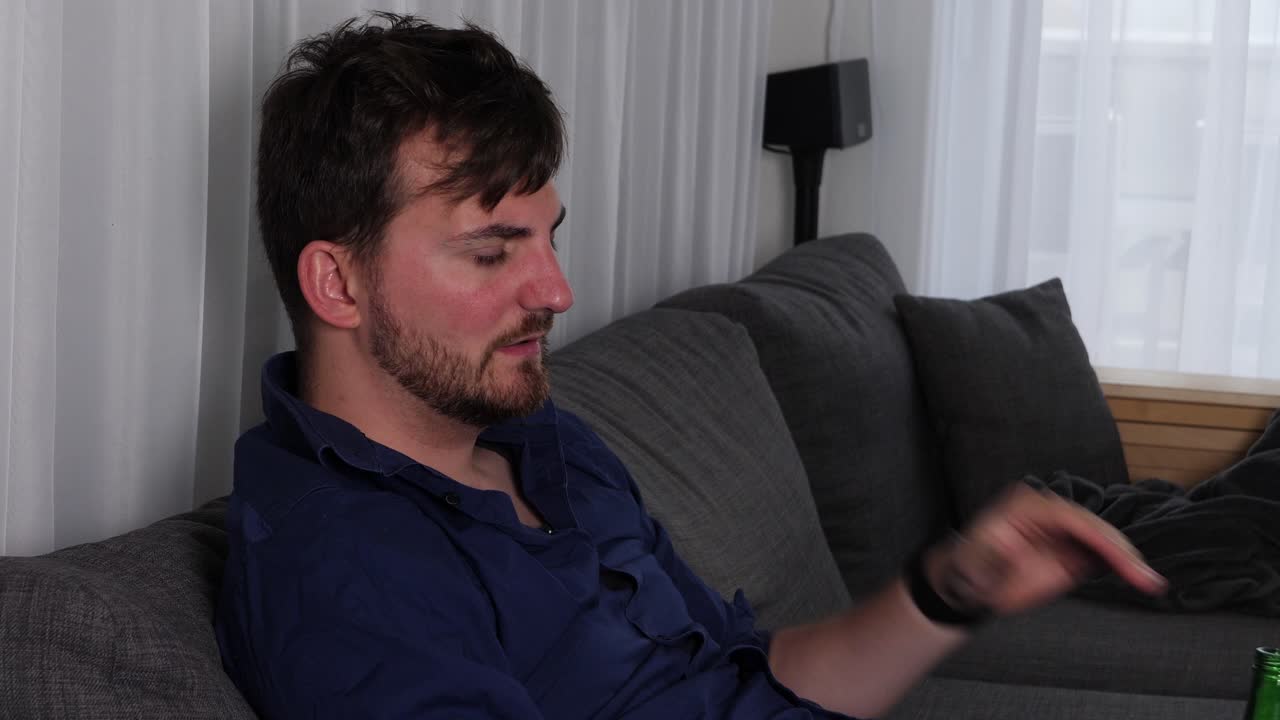 Desperate And Drunk Man Drinking On The Couch In His Living Room Free