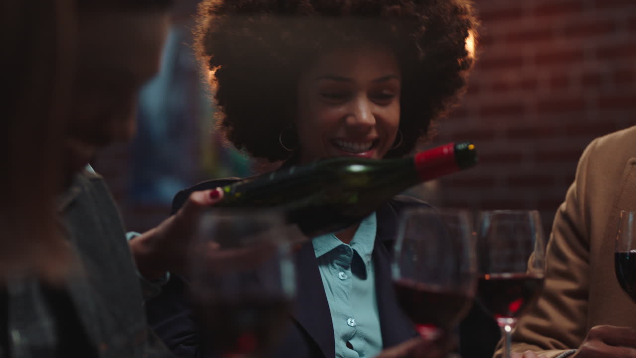 Diverse group of friends drinking wine having fun in restaurant ...
