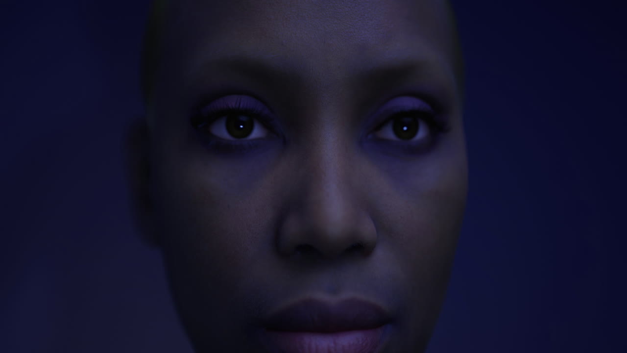 Expression of emotion captured in dim lighting with focus on the face ...