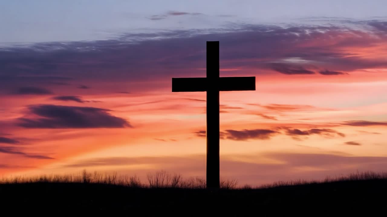 Lone cross silhouetted against a vibrant sunset sky, creating a serene ...