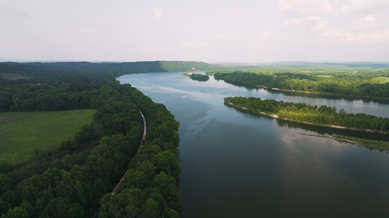 Aerial slide left revealing train on railway through spadra park ...