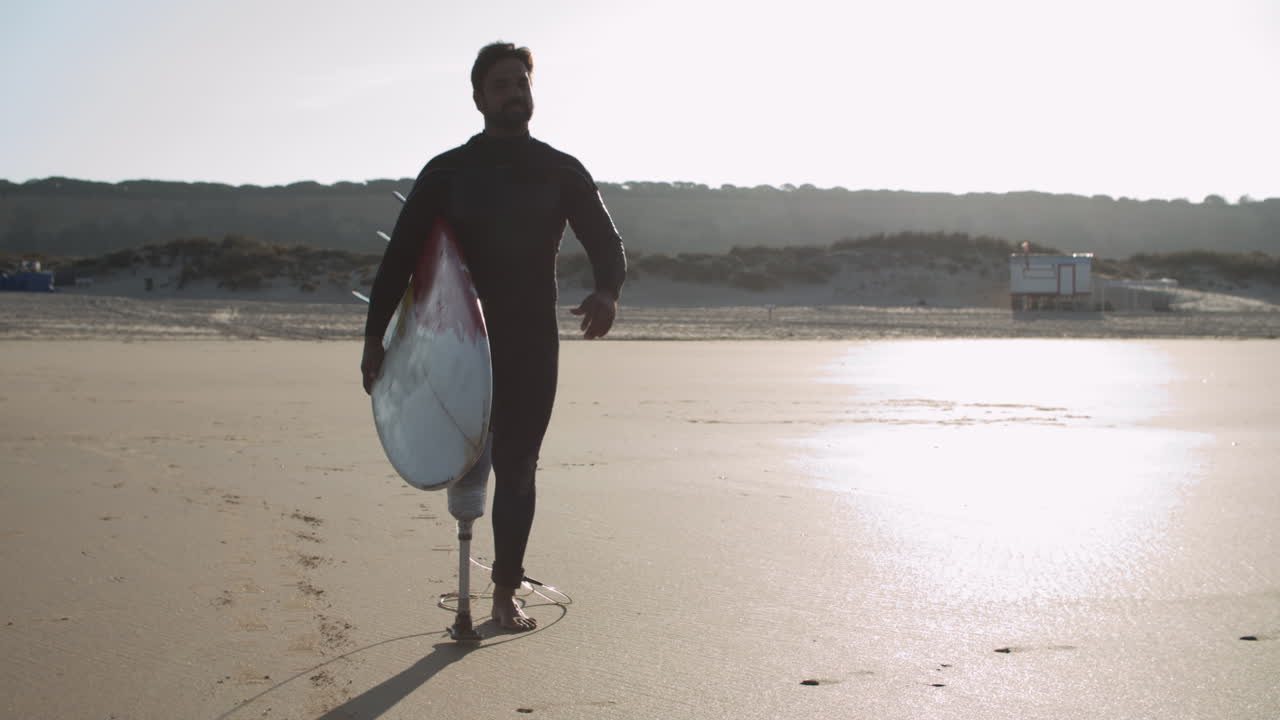 Free stock video - Front view of a male surfer with artificial leg ...