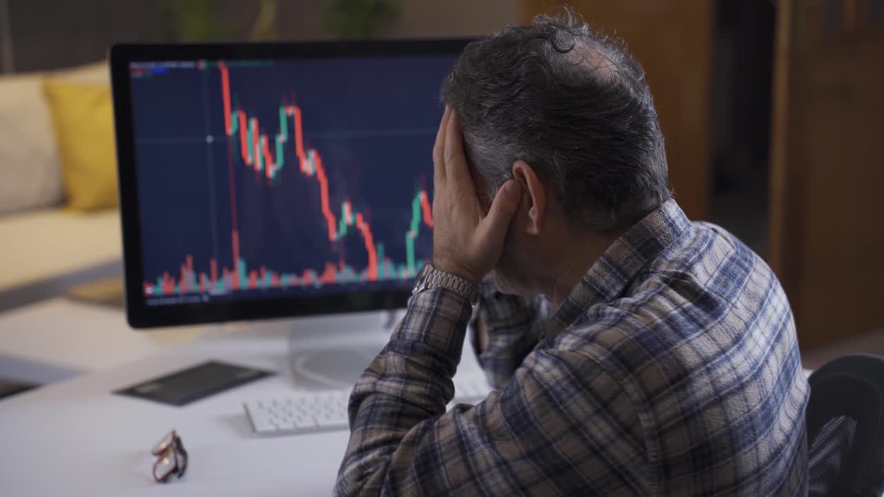 Stressed Trader At Home Watching Stock Market On Laptop And Getting