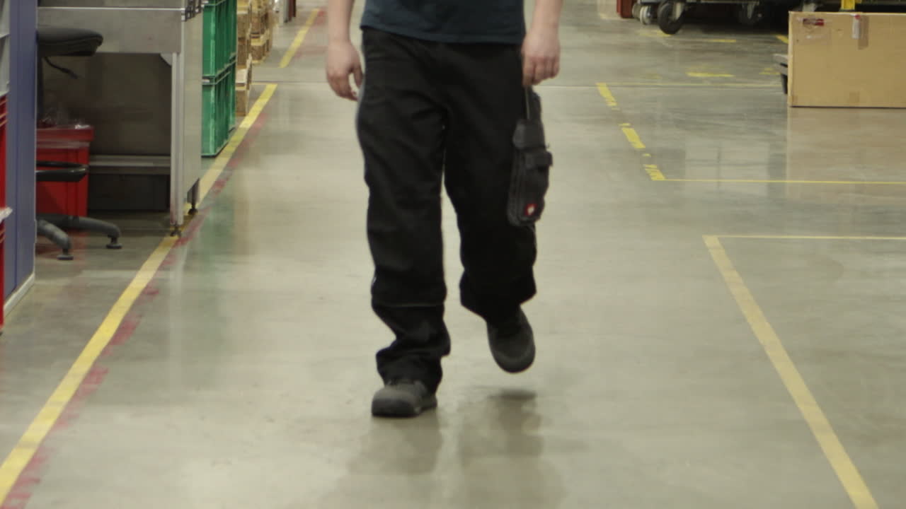 Premium stock video - Worker walking alone inside a factory industrial ...