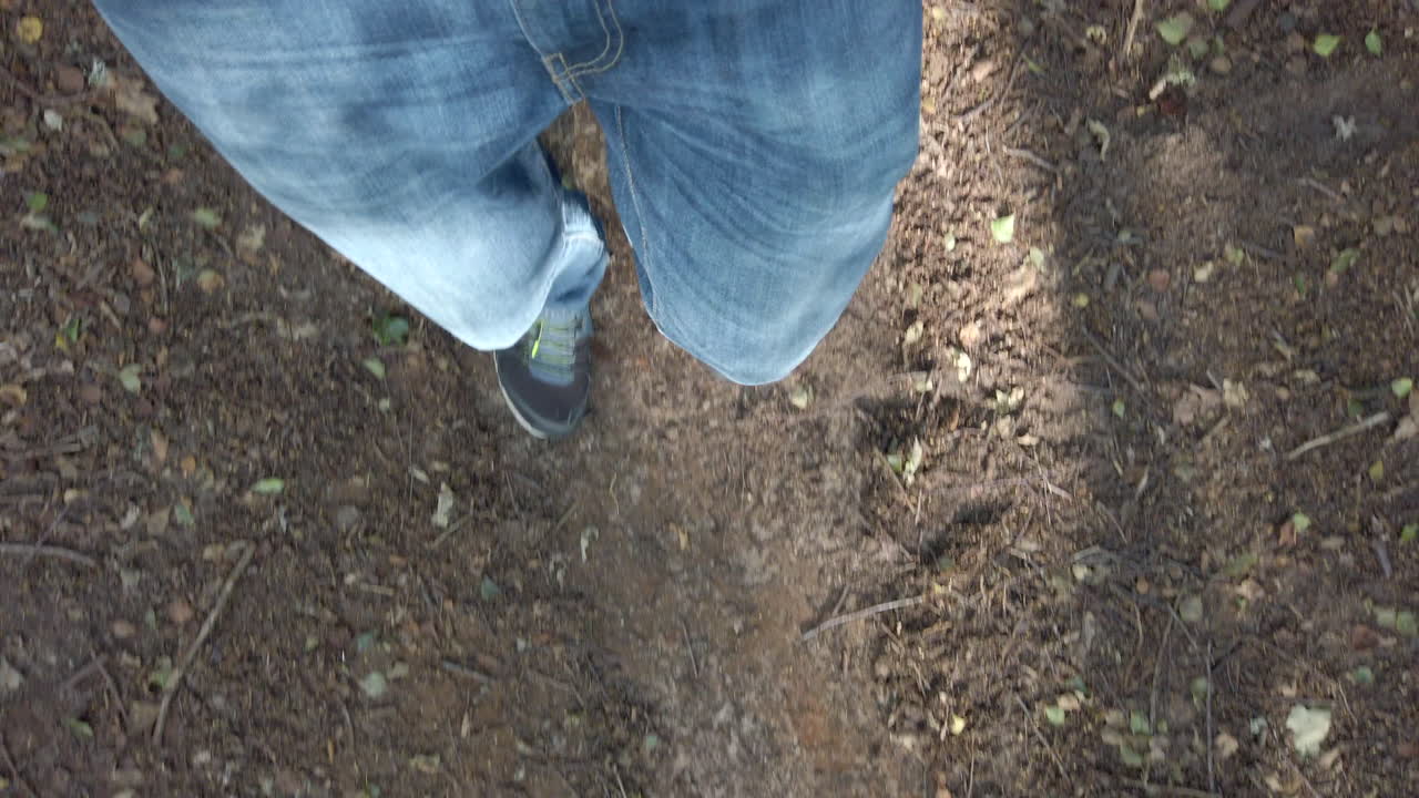 Premium stock video - Male legs walking downhill in the countryside