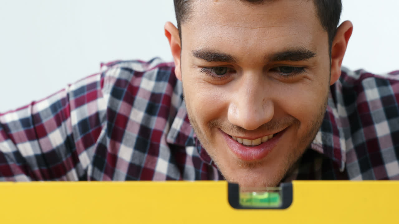 Male Architect Measuring Plywood With Engineer Scale Against White ...