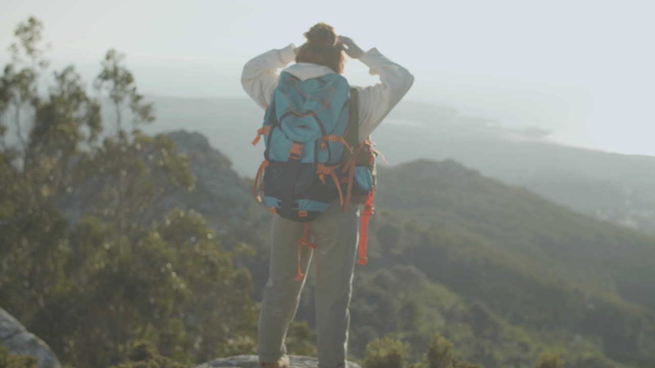 Back View Of A Female Hiker Standing On The Mountain Top With Hands Up ...
