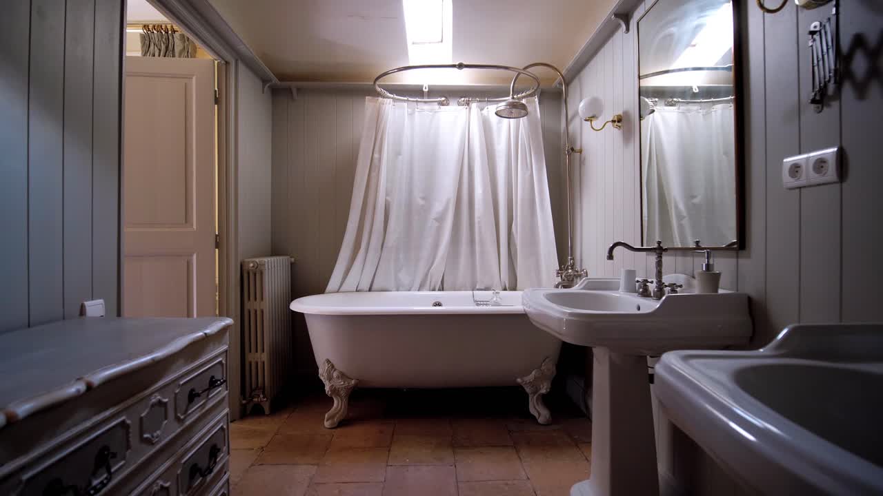 Premium stock video - Slow pull out shot of an antique bathroom within ...
