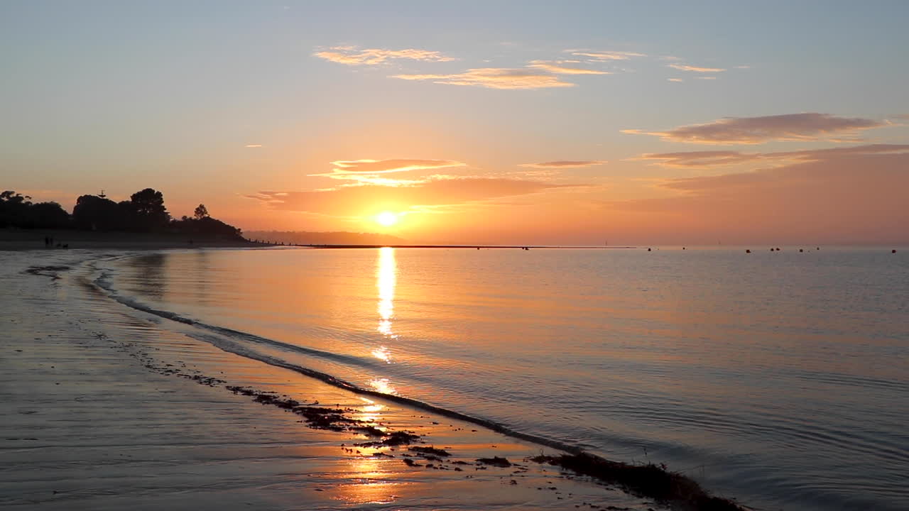 Premium stock video - Beautiful sunrise over still, calm water with ...