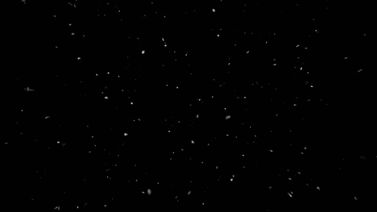 Realistic heavy snow flurry with varied particle sizes falls against ...