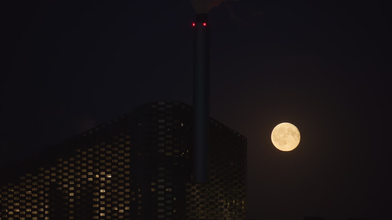 Full moon illuminating the Copenhill Amager Bakke waste to energy plant ...