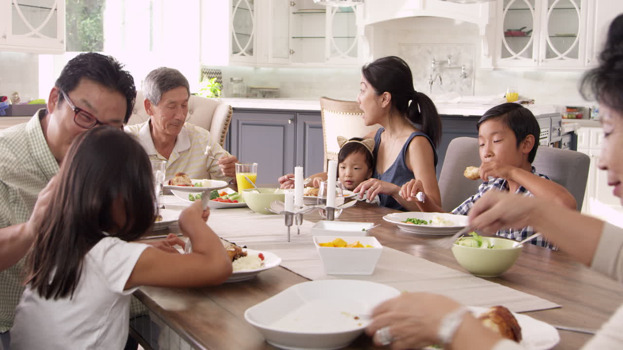 Premium stock video - Extended family group eating meal at home shot on r3d