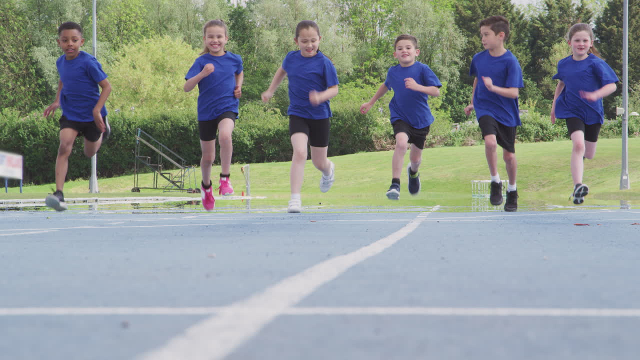Children On Athletics Track Running Race On Sports Day | Premium Stock ...