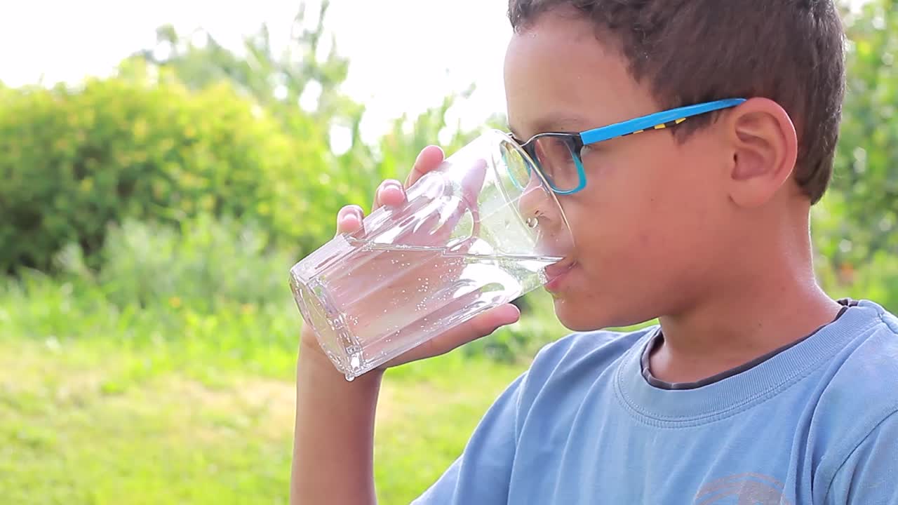 Premium stock video - Drinking water from glass thirsty boy sock footage
