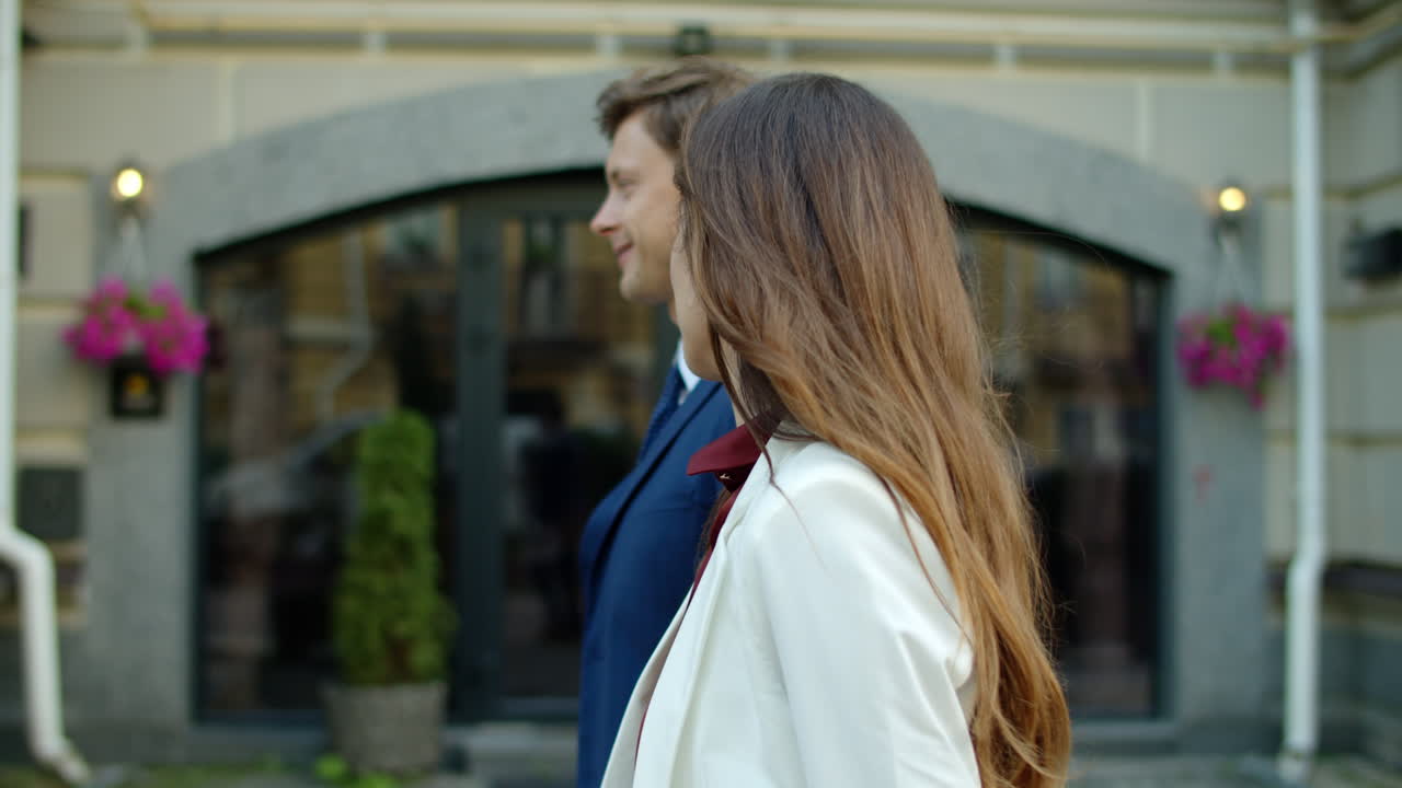 Cheerful business couple walking outdoors. happy partners walking to ...