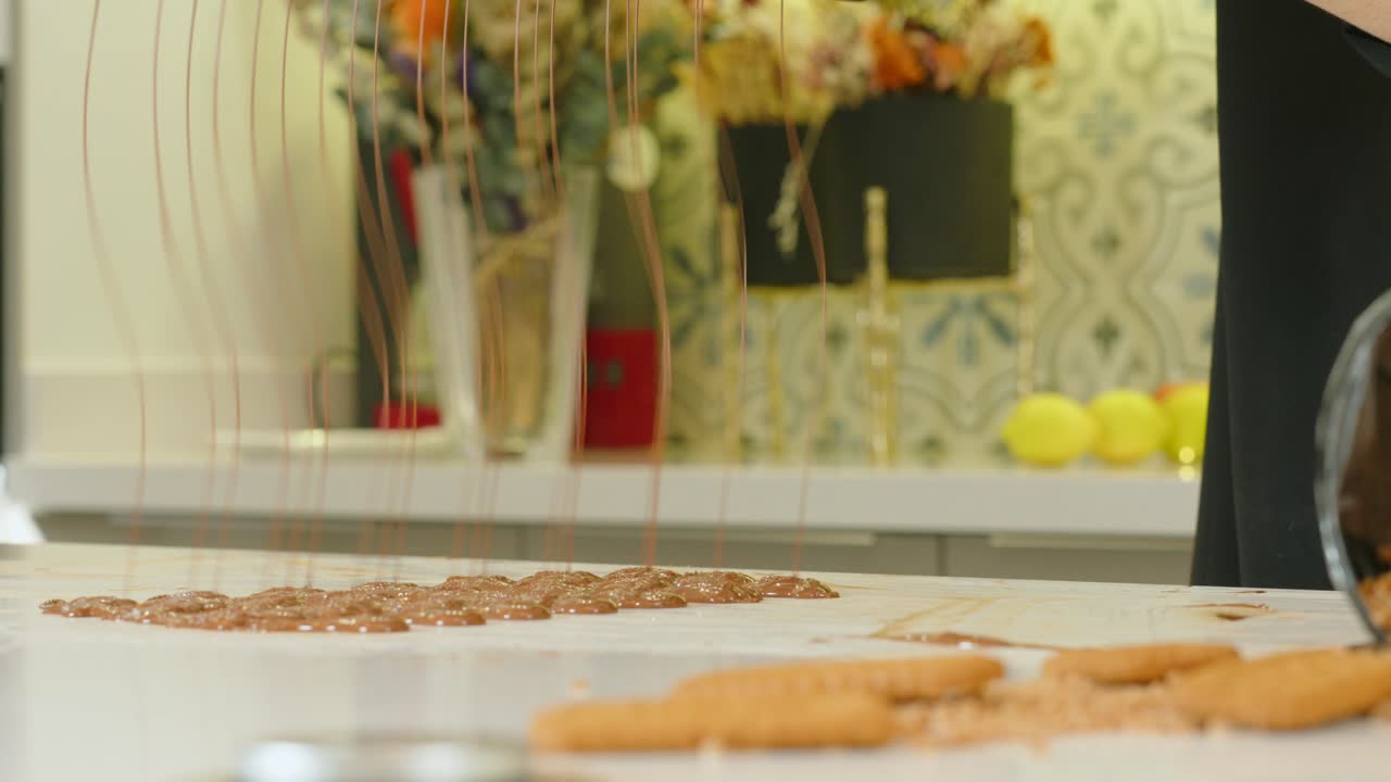 Premium stock video - Chef temper chocolate by tabling, pouring melted ...