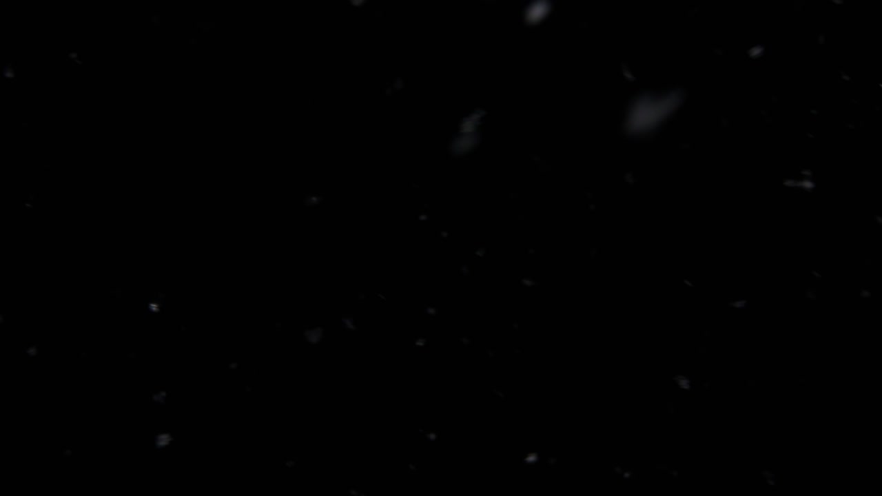 Premium stock video - Fast falling close-up of small snowflakes in a ...