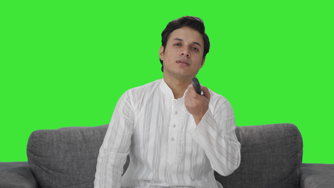 Sleepy Indian man watching TV Green screen | Premium Stock Video Footage