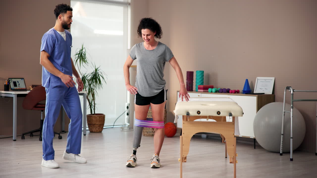 A physical therapist helps a patient with a prosthetic leg perform ...