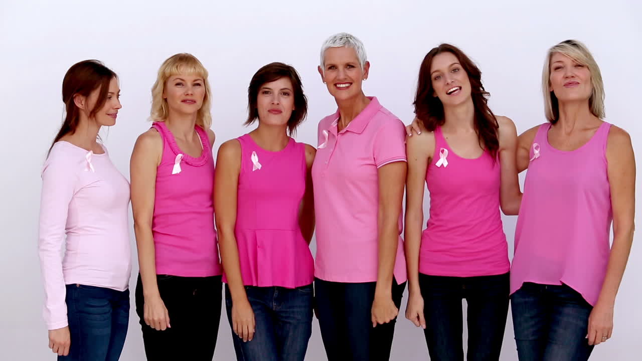 Premium stock video - Women giving thumbs up for breast cancer awareness