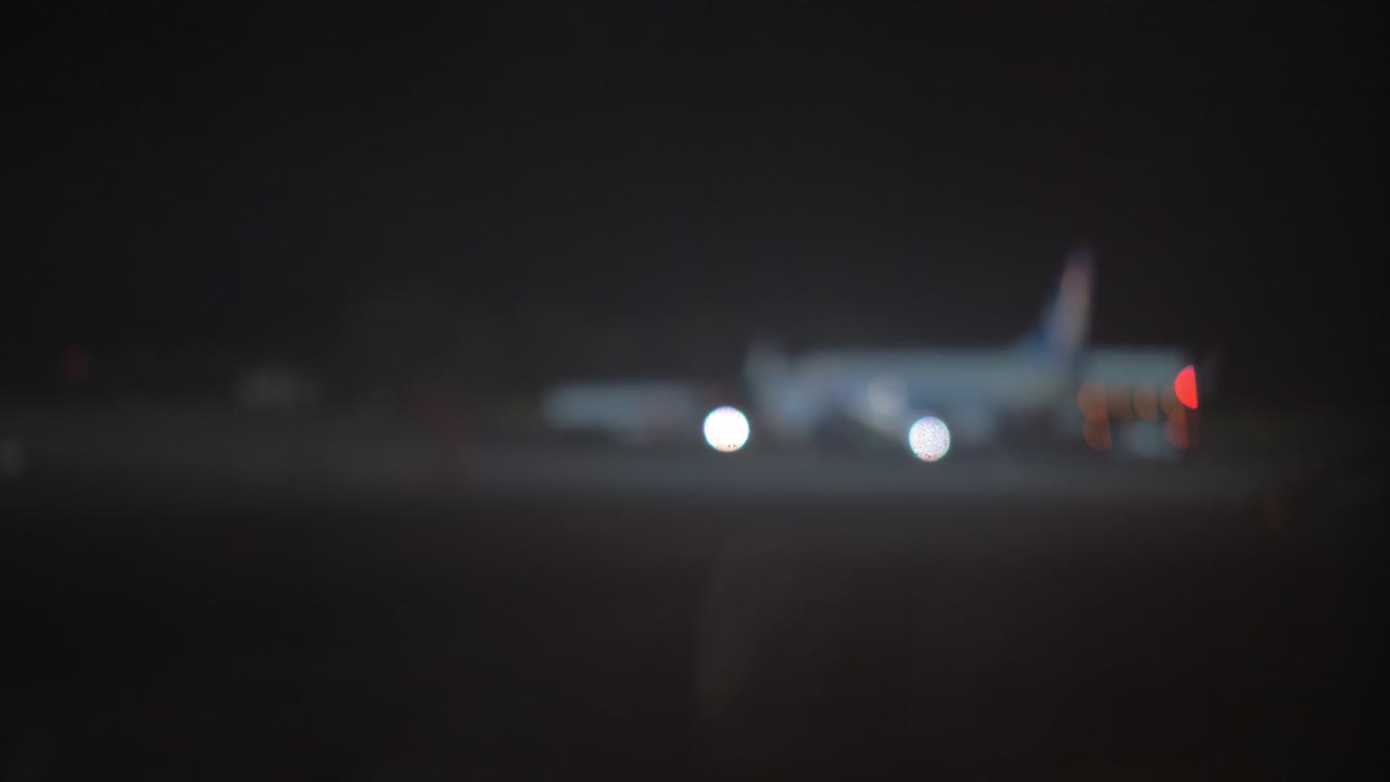 Premium stock video - Night view of plane and aircraft tow tractor at ...