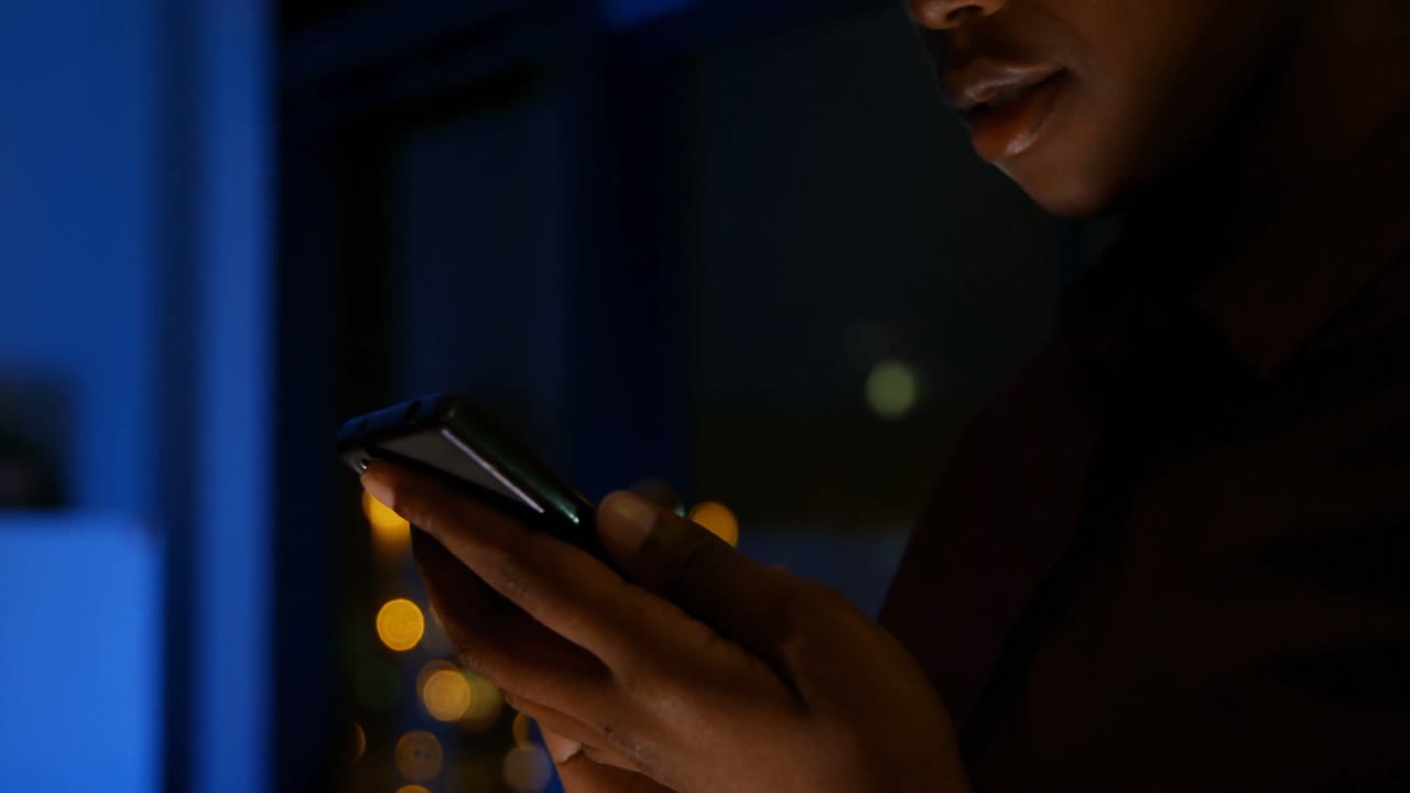 Premium stock video - Female executive using mobile phone 4k