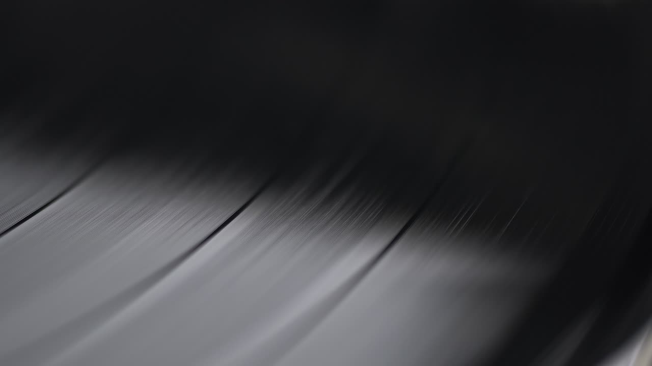 A close-up of a spinning vinyl record. Start and stop of disk rotation ...