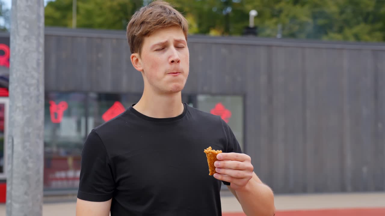 Athletic white man chews on protein bar, slow contemplative motion ...