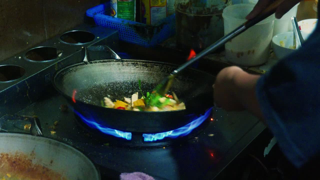 4k cinematic cooking footage of a thai chef cooking thai food in a wok ...