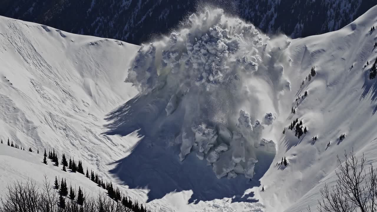 A dynamic video captures a powerful avalanche cascading down a snowy ...