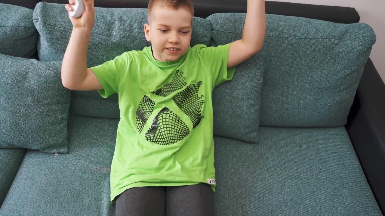 Premium stock video - Kid plays console