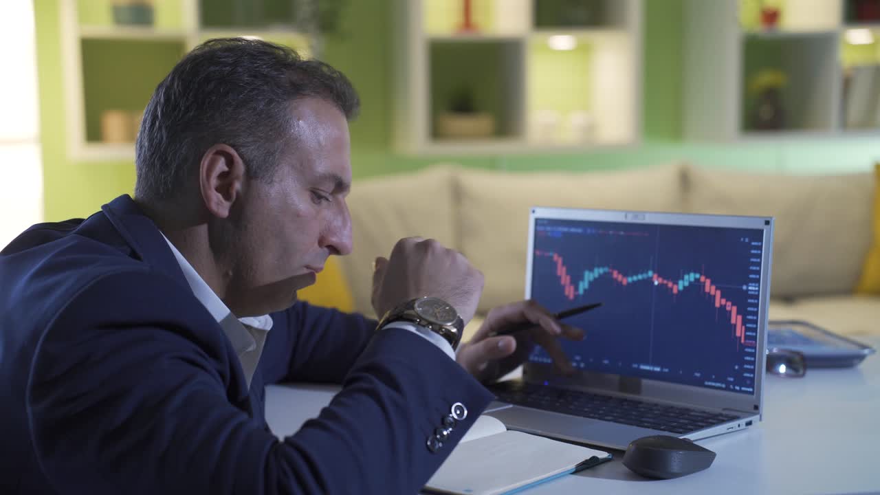 Premium stock video - Stock trader man analyzing the stock market ...