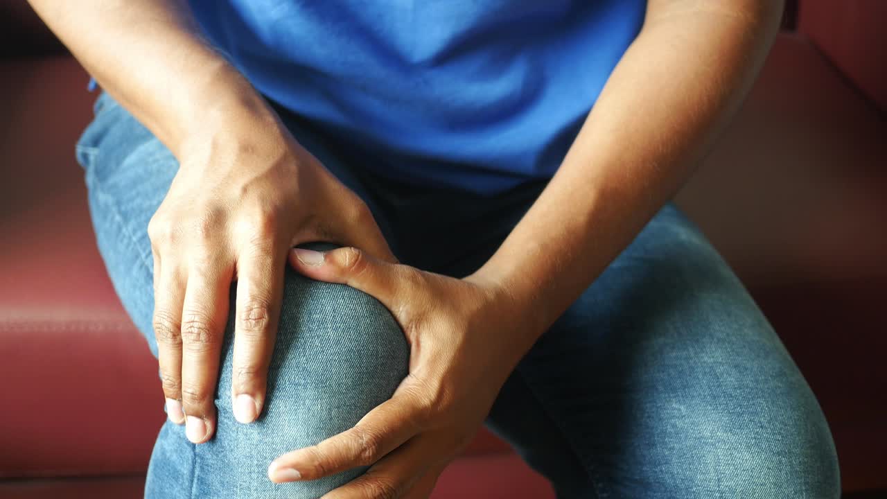 Premium stock video - Close up on man suffering knee joint pain
