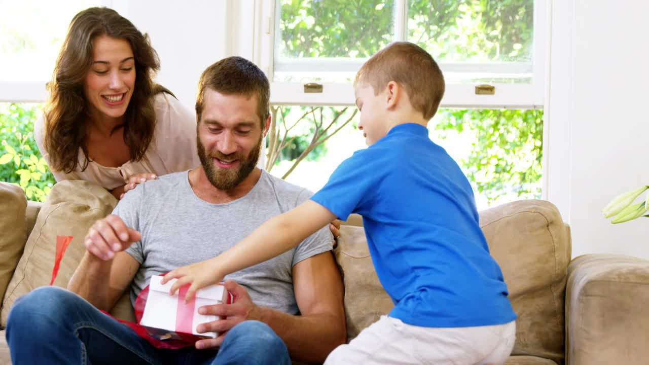 Premium stock video - Father opening his gift