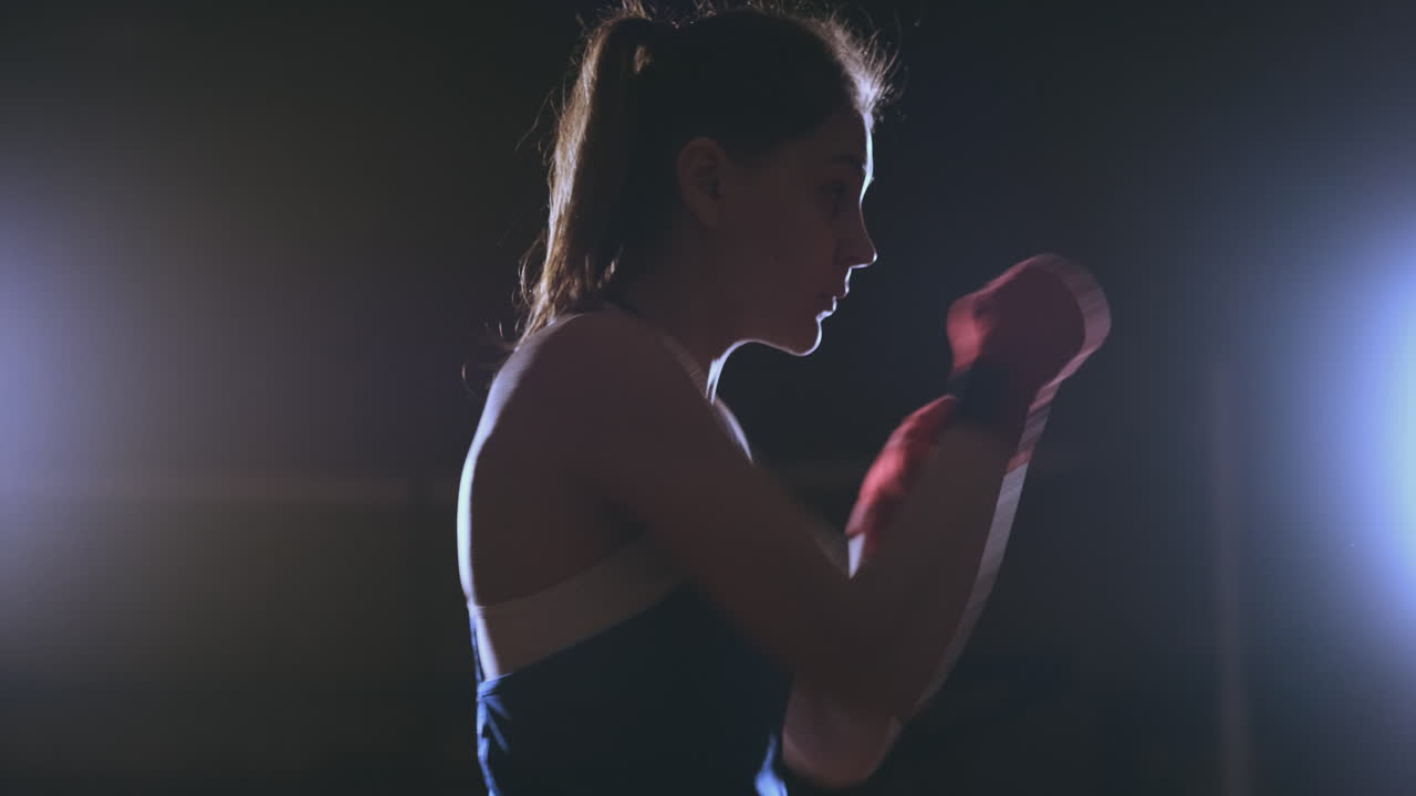 Premium stock video - Training a beautiful female boxer doing punches ...